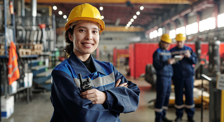 Smiling female worker in industrial workwear
