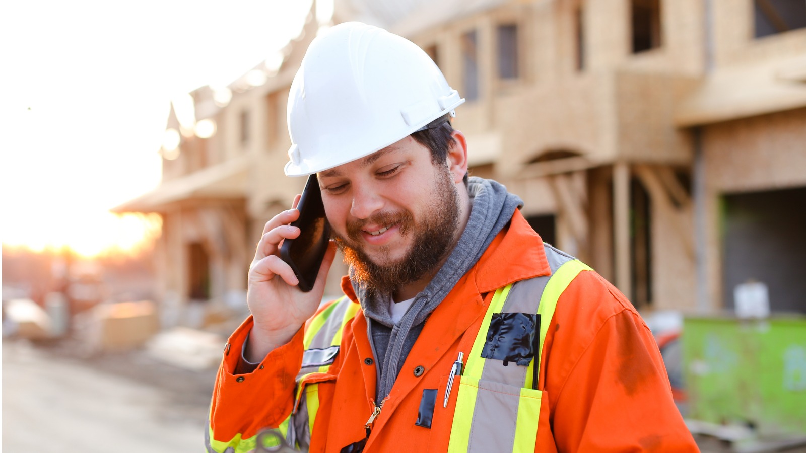 Portrait of man in high visibility attire on the phone.